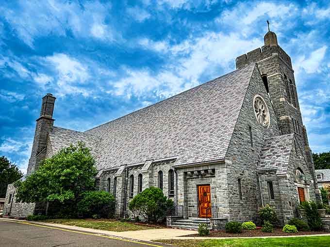 Assumption Church rises against a dramatic sky, its gray stone walls looking like they were carved straight from Connecticut bedrock.