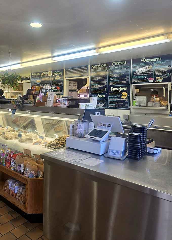 The order counter at Fishetarian, where the chalkboard menu covers everything from oysters to desserts. This is where good decisions get made.