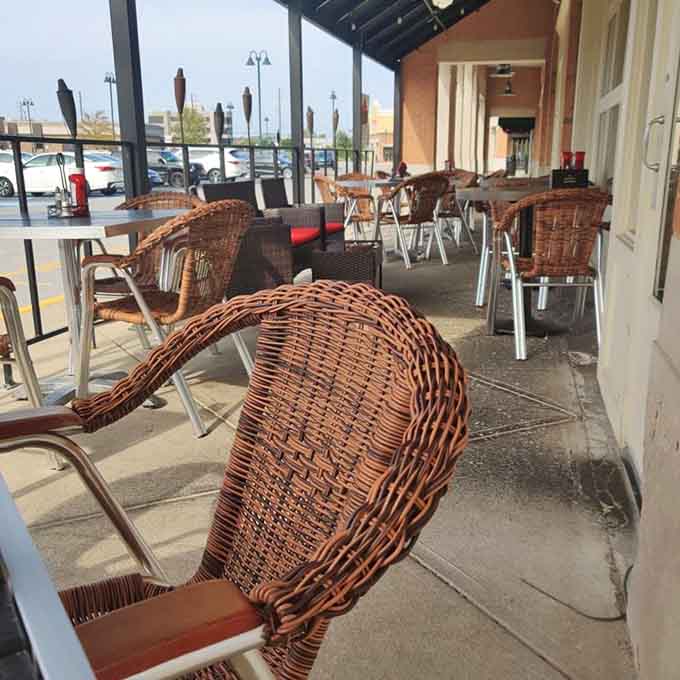 Wicker chairs lined up along a quiet patio, just waiting for someone smart enough to show up hungry.