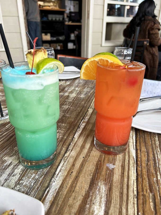 Colorful cocktails that look like they belong on a beach somewhere, complete with fruit garnishes doing their best work.