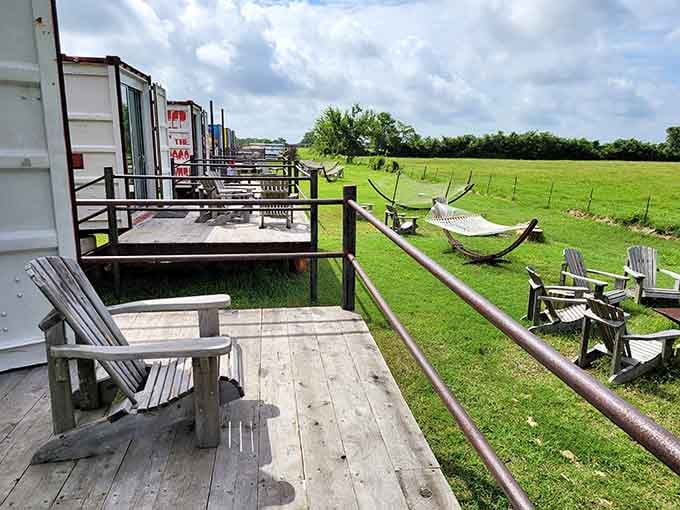 A long row of private decks, Adirondack chairs, and hammocks stretching into the green. This is what slowing down actually looks like.