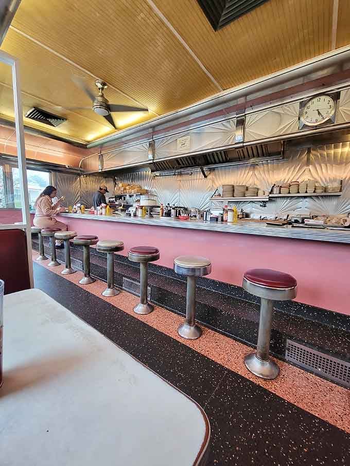 Pink walls, terrazzo floors, a ceiling fan, and a clock that's been keeping honest time for decades.