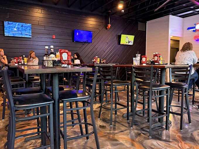 High-top tables, dark wood walls, and TVs humming in the background. This is the neighborhood spot everyone wishes they had.