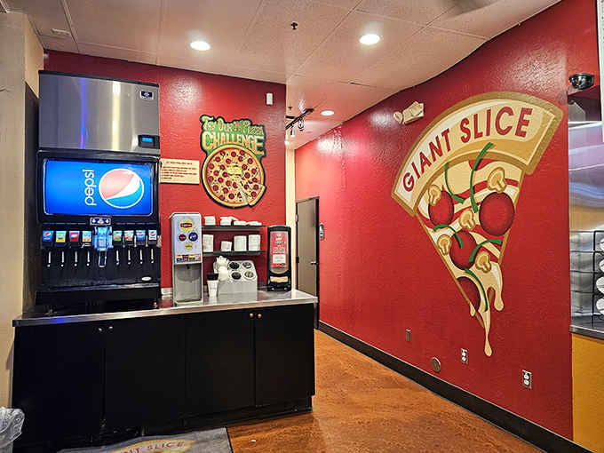 A bold red wall, a giant slice mural, and a Pepsi fountain. This room means serious, unapologetic business.