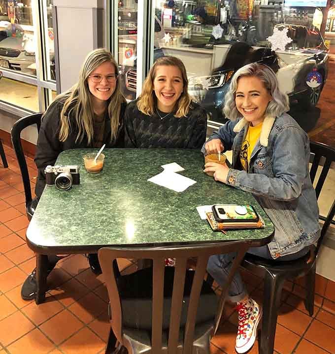 Three friends, green-topped tables, and custard in hand. This is exactly what a good Tuesday looks like.