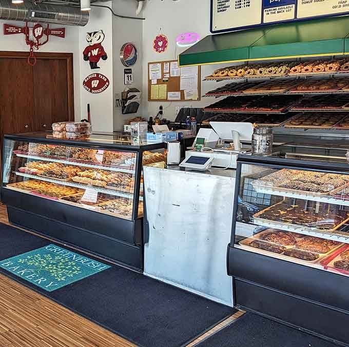 Behind this counter, rows of donuts stretch back like a delicious horizon you never want to stop staring at.