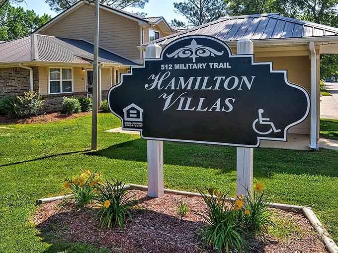 Hamilton Villas on Military Trail greets you with day lilies and a sign that means business about community.