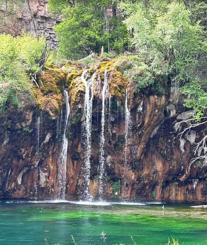 Mineral-rich water creates ribbons of white against rust-colored rock, painting nature's own abstract masterpiece daily.