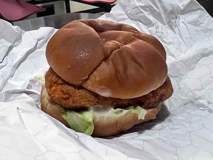 That gloriously golden, crispy-crowned chicken sandwich sitting in its foil wrapper is proof that Henry's doesn't play favorites with greatness.