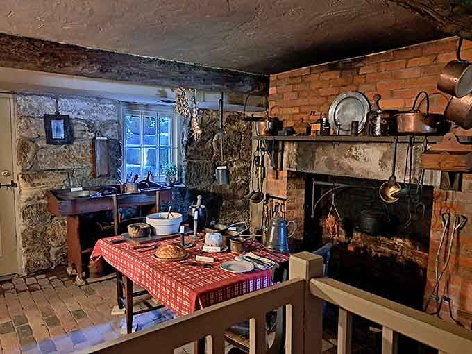 Copper pots, a brick hearth, and a checkered tablecloth that make you genuinely reconsider your microwave at home.