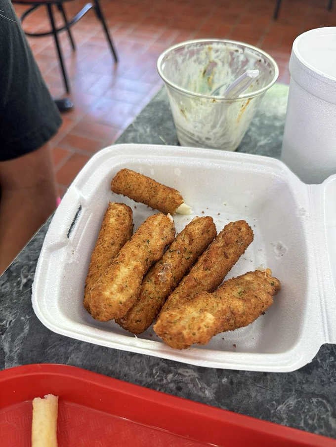 Golden, crispy mozzarella sticks at Homer's prove the savory menu deserves just as much attention as the ice cream.