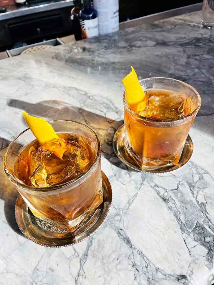 Two old fashioneds on a marble bar top, simple, elegant, and absolutely no apologies needed for ordering a second round.
