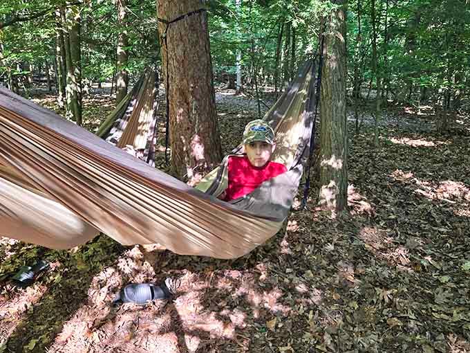 Strung between two trees with nowhere to be. This kid has officially figured out life.