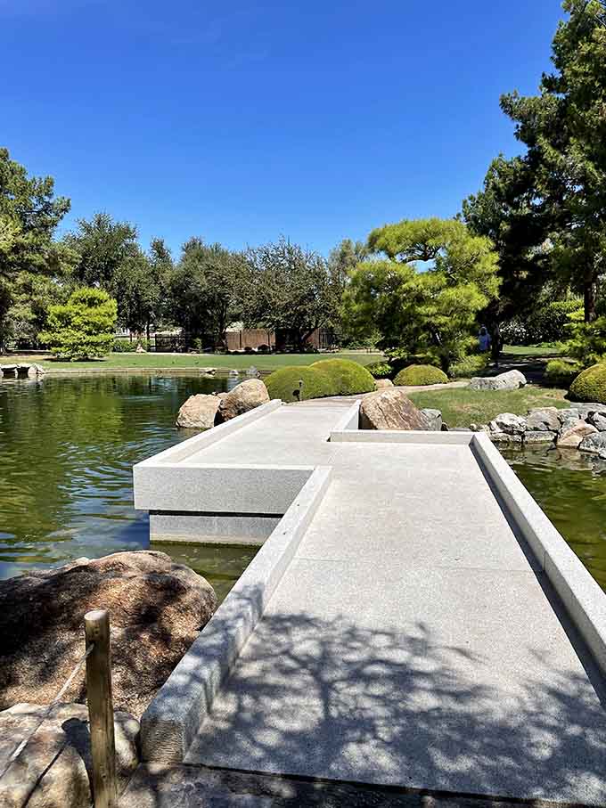 Flat granite walkways stretching right over the water, with moss-dotted boulders on both sides. Go ahead, take the scenic route.