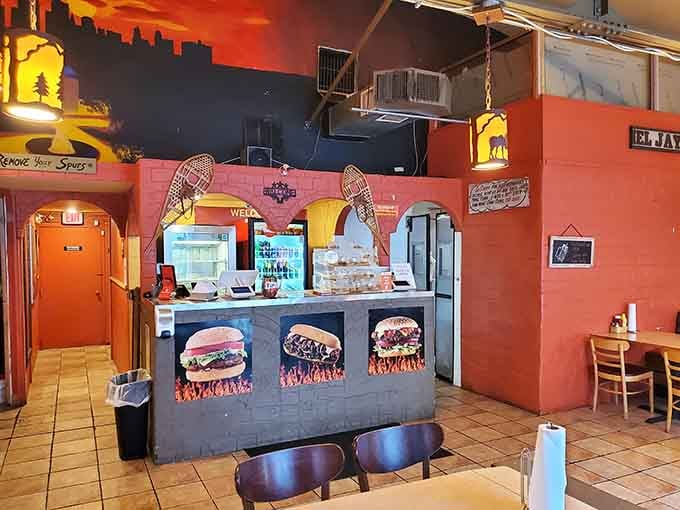 The counter decorated with burger photos is basically a delicious preview of coming attractions for your taste buds.