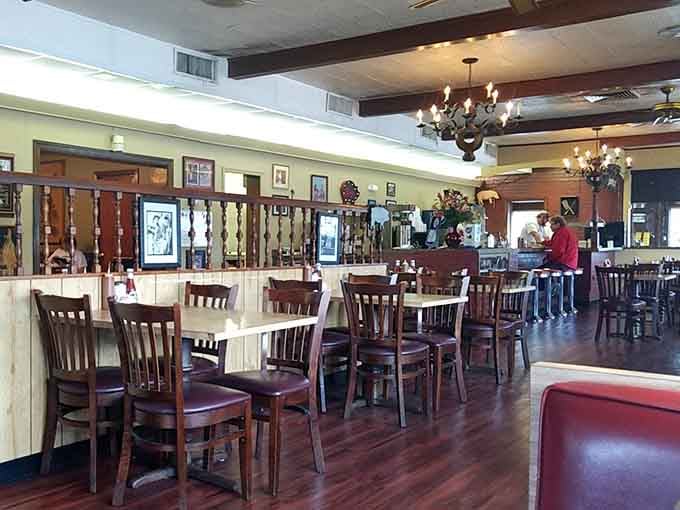 Chandeliers, framed photos, dark wood beams, and booths that have heard a thousand good conversations. Comfort lives here permanently.