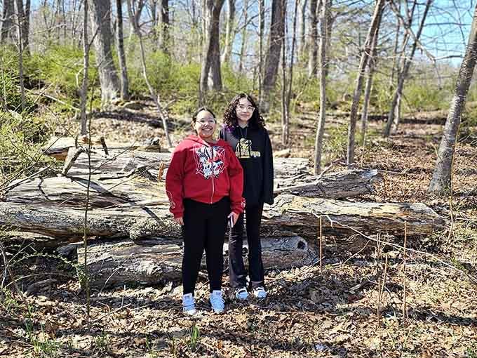 Two visitors pausing on a spring trail, because sometimes the best thing you can do is just stop and look around.