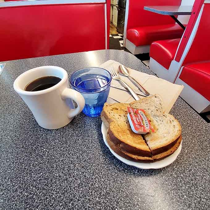 Black coffee, buttered toast, and a blue glass of water. Sometimes the simplest things are the most satisfying.
