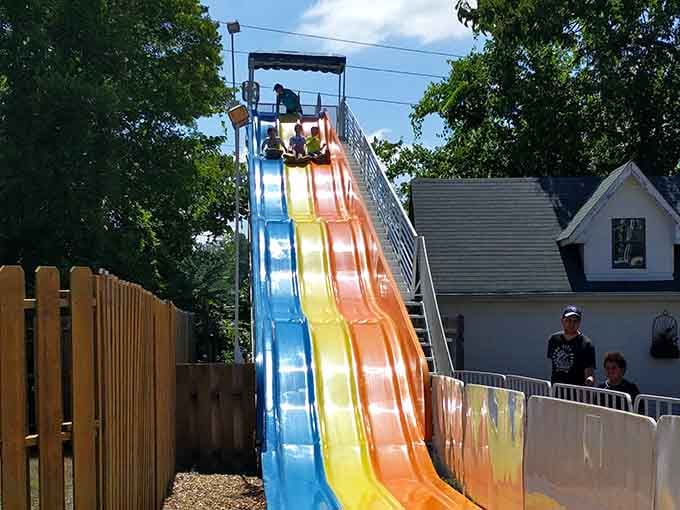 Three lanes of pure rainbow-colored speed, and that grinning kid at the bottom just won the afternoon.