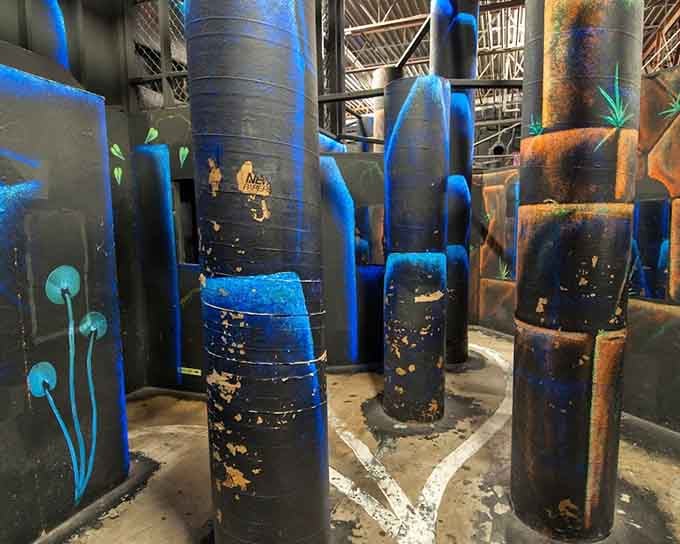 Glowing blue mushrooms, towering dark columns, and black light murals, this arena looks like something straight out of Avatar.