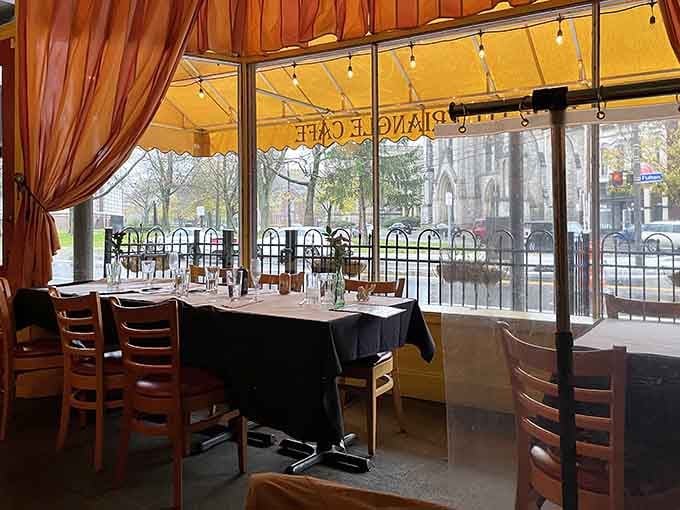 Window seating with draped curtains and string lights creates that perfect people-watching spot for leisurely weekend brunching.