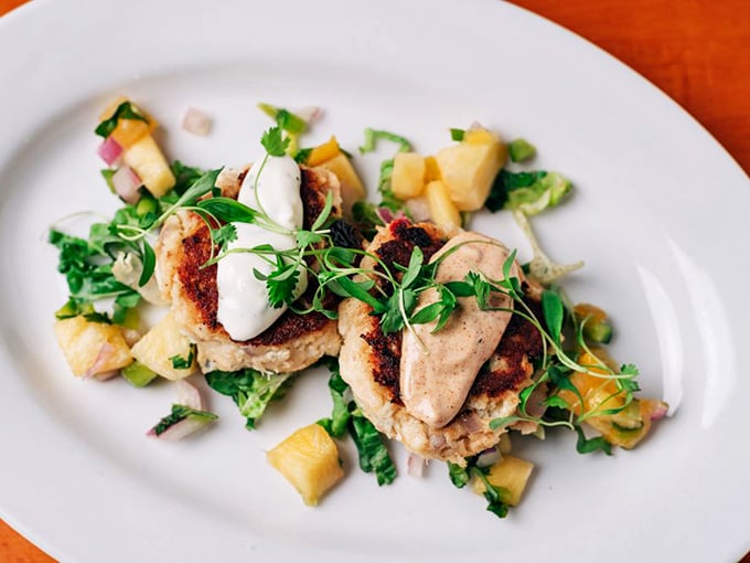 Seared golden and plated beautifully, these crab cakes arrive like the well-dressed guests everyone hopes show up.