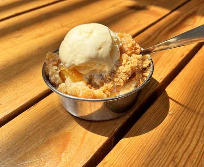 Warm peach cobbler topped with vanilla ice cream is the sweet ending every historical feast deserves.