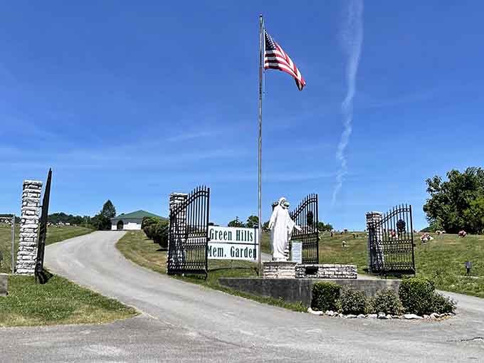 Green Hills Memorial Gardens sits beneath a brilliant blue sky, the flag snapping proudly above the iron gates.