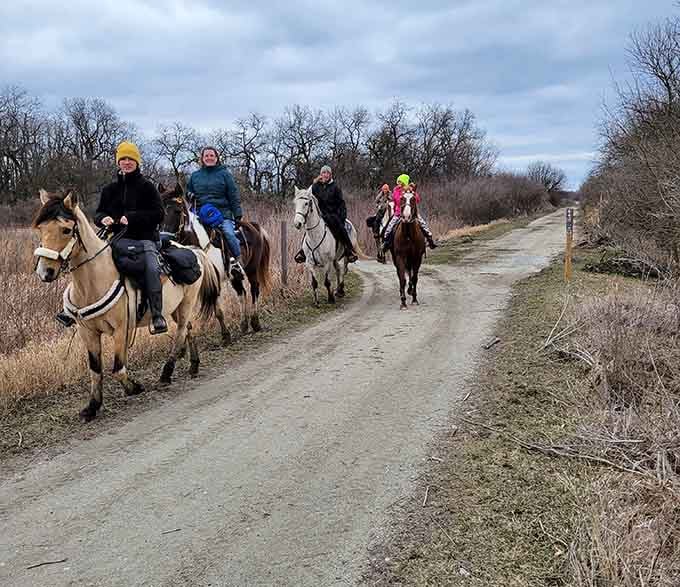 Horseback riders on the trail, living their best prairie life while the rest of us are still finding parking.