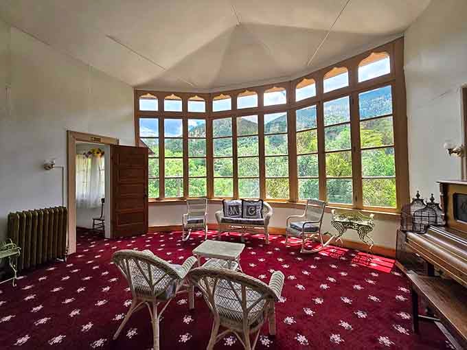 Floor-to-ceiling windows framing mountain views so spectacular they make the wicker furniture look like fine art.