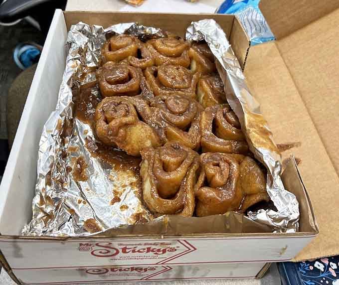 A full dozen nestled in foil, warm and ready, the kind of box that makes an office genuinely love you.