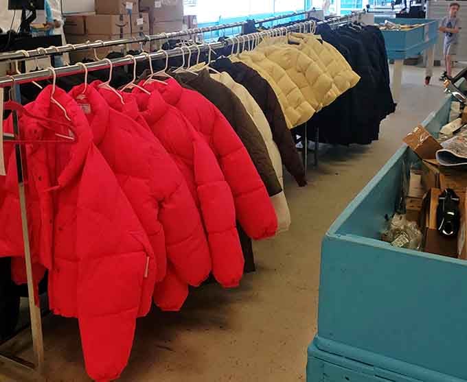Puffy red jackets pop against the neutral tones beside them, bold enough to be spotted from across a parking lot.