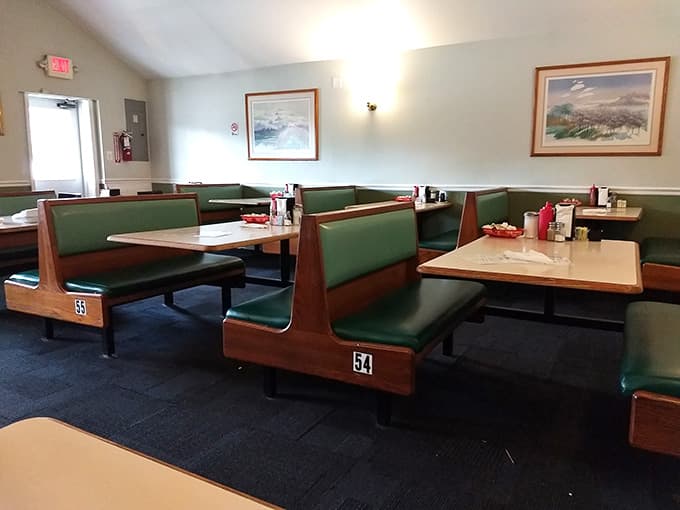 Numbered booths, green cushions, framed artwork on the walls. Simple, clean, and built for serious eating.