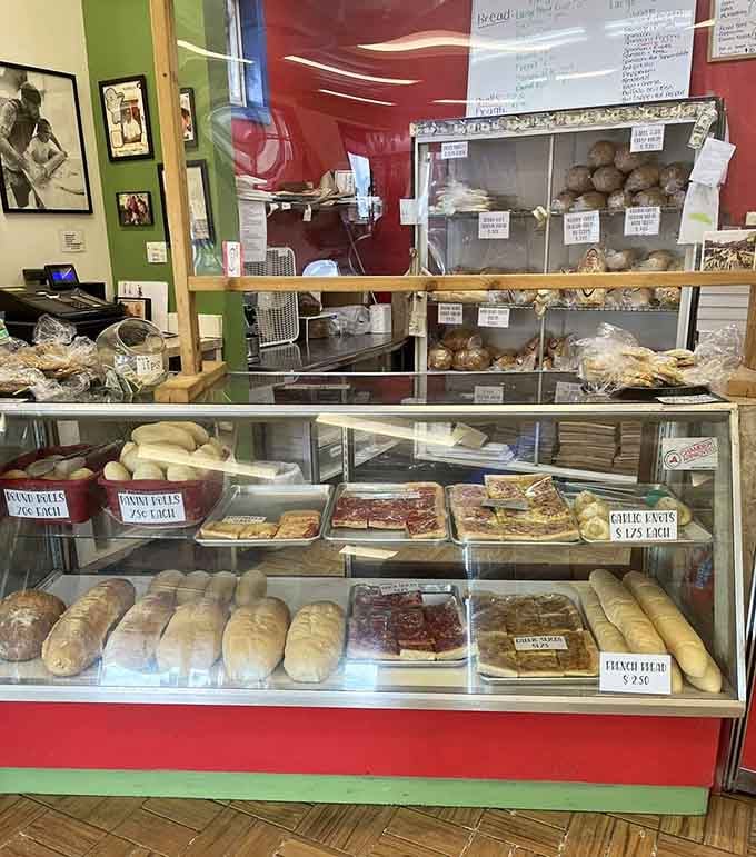 Fresh loaves, tomato pie squares, and garlic knots lined up in the display case like a very edible hall of fame.
