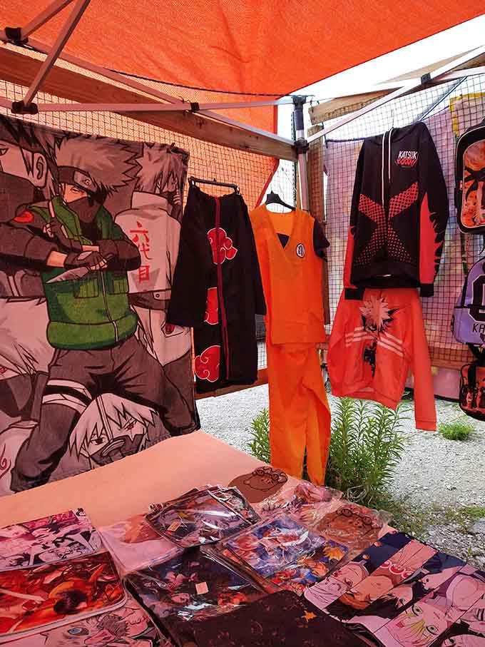 Akatsuki robes and Dragon Ball Z tracksuits hanging proudly, turning this outdoor stall into the coolest corner of the market.