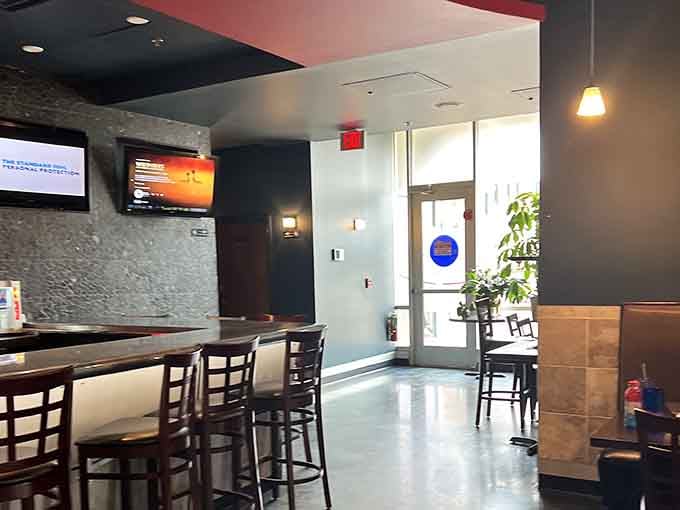 Bar stools, mounted screens, and an easy path to the door. Though honestly, leaving early seems like a terrible idea.