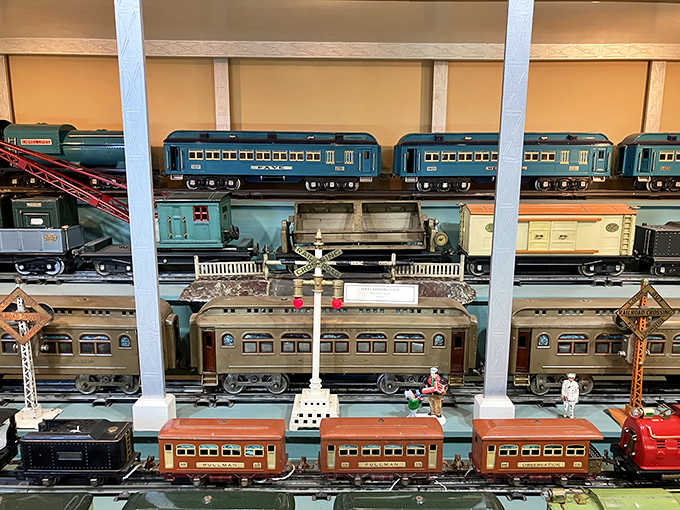 Pullman cars, passenger coaches, and crossing signals all together, like a tiny golden age of American rail travel frozen in time.