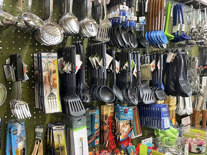 Every spatula, ladle, and kitchen tool you never knew you needed, all hanging there like a very useful art installation.