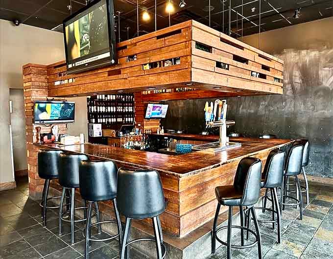 A handsome wooden bar with multiple taps and TVs overhead, the kind of spot where hours disappear happily.