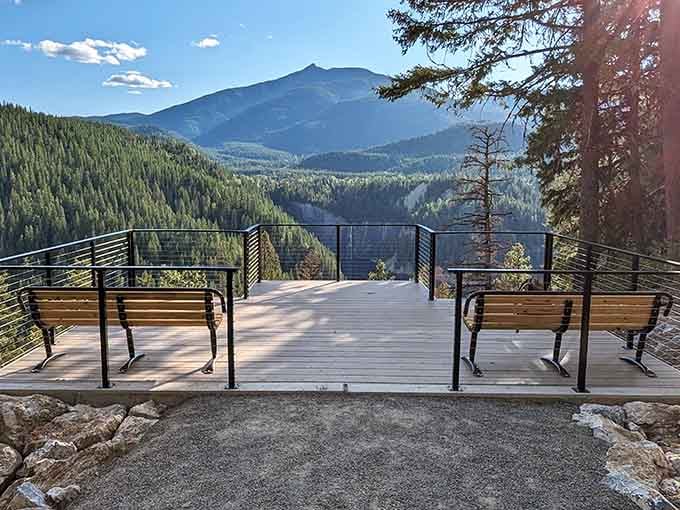 The Peewee Falls Overlook deck offers benches, mountain views, and a strong argument for moving to northeastern Washington permanently.
