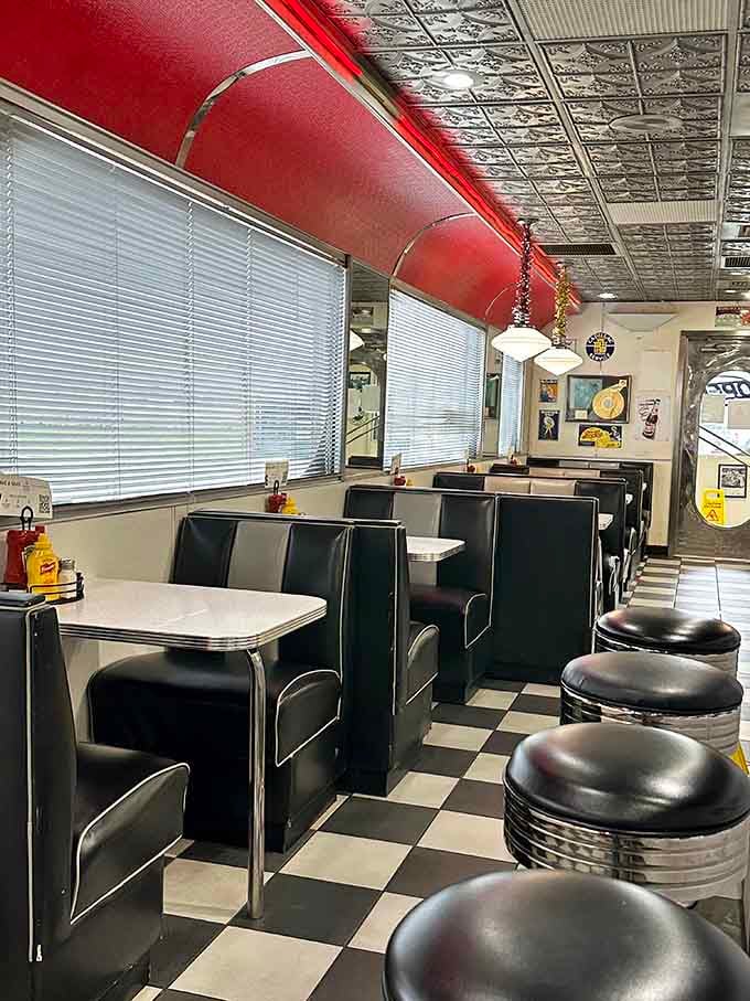 Sleek black booths, white tables, and that iconic checkered floor. Penny's Diner seating is pure nostalgia.