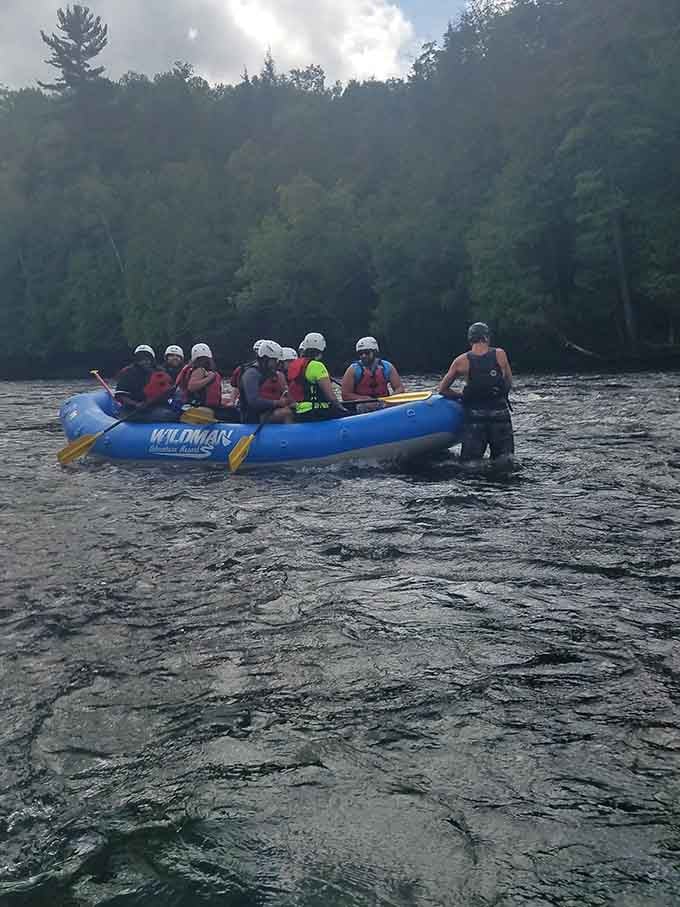 Wildman Adventures guides a raft full of brave souls through the Menominee, helmets on and grins firmly in place.