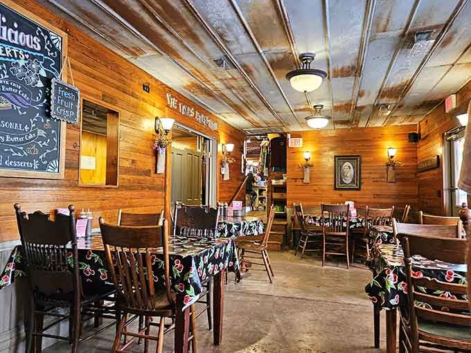 A quieter dining room corner with warm wood walls and chalkboard dessert specials, cozy doesn't even begin to cover it.