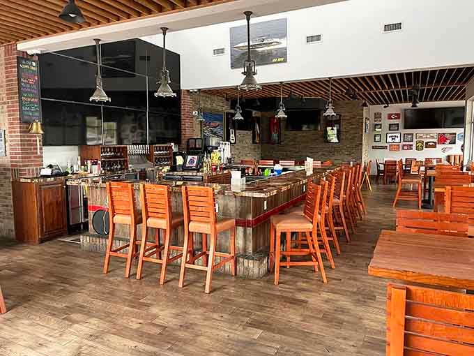 A well-stocked bar, warm pendant lights, and open space, the kind of setup that says, "Stay a while."