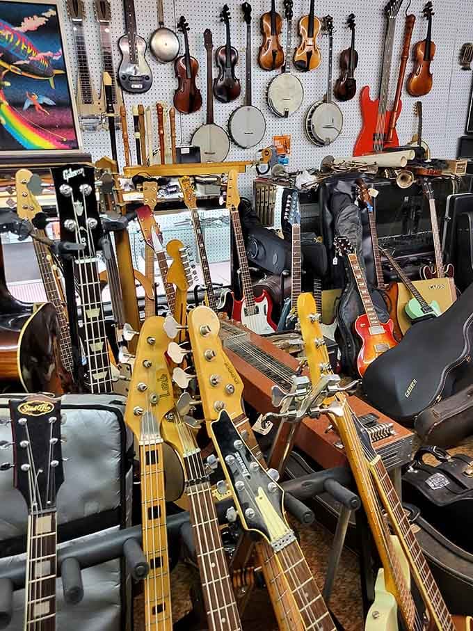 Guitars, banjos, and violins crowd every inch of one booth, turning a casual browse into an impromptu music appreciation class.