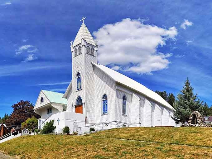 Immaculate Conception Catholic Church rises against a brilliant blue sky, its white steeple a beacon for this tight-knit community.