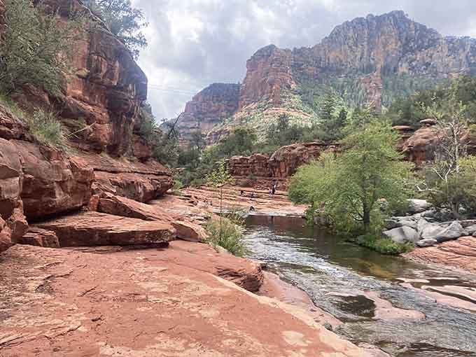 Flat red rock slabs stretching along the creek, nature's version of prime real estate with the best possible view.