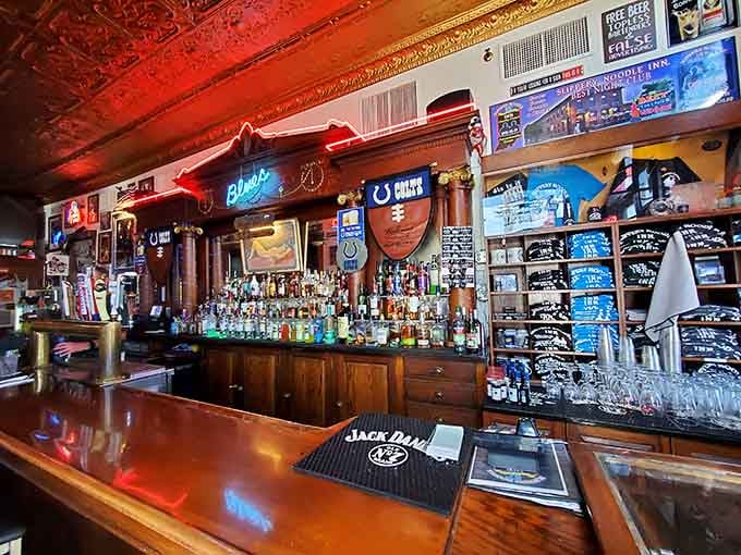 A bar top polished by decades of elbows, a back bar stocked to the rafters, and a neon Blues sign that says it all.