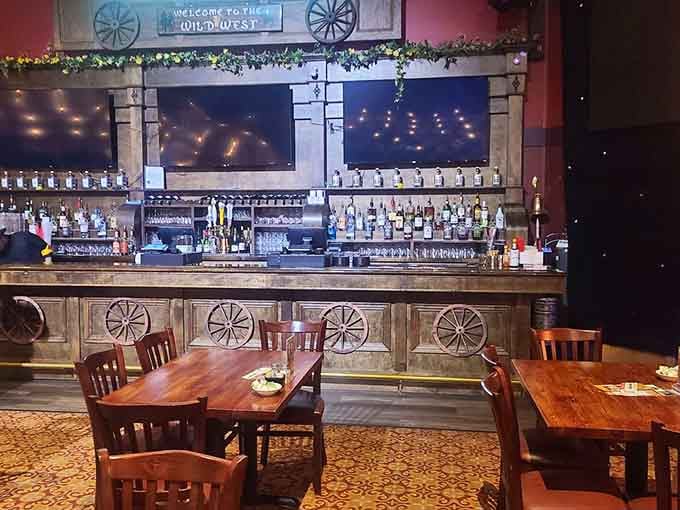 Wagon wheels on the bar front, bottles lined up like soldiers. The Wild West never looked this well-stocked.