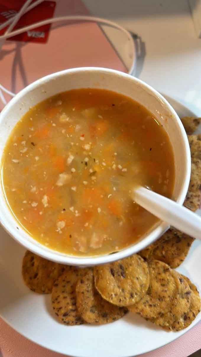 Thick, hearty, and loaded with vegetables, this bowl of soup arrives with crackers like it already knows exactly what you need today.